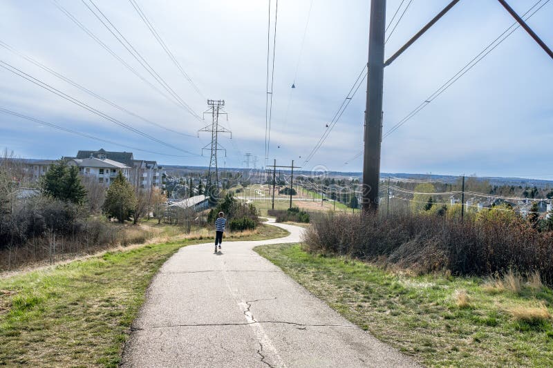 A Running Downhill Boy on Paved Park Path Editorial Photography - Image ...