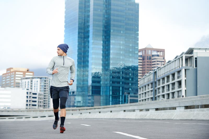 Running through the Empty Roads. a Young Man Jogging through Empty City ...