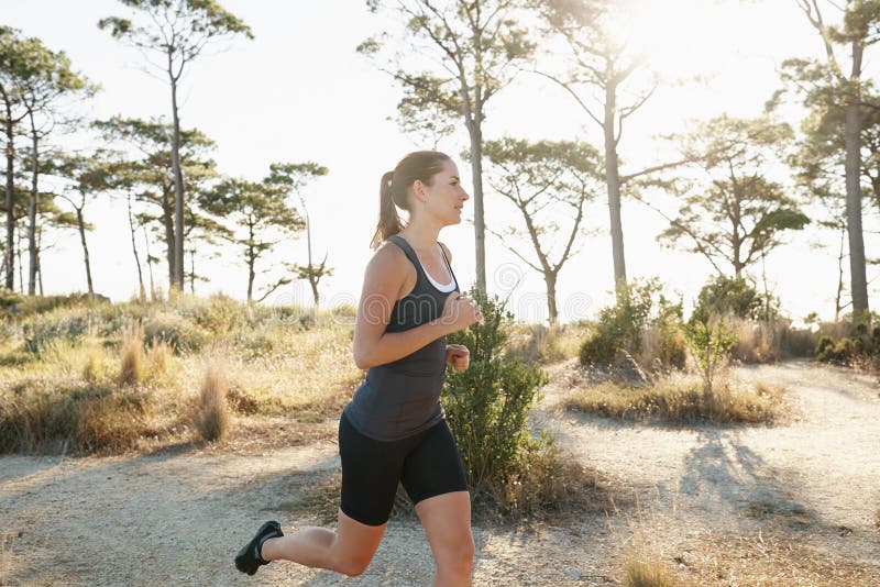 Running Faster Than the Wind. a Beautiful Young Woman Training Outdoors ...