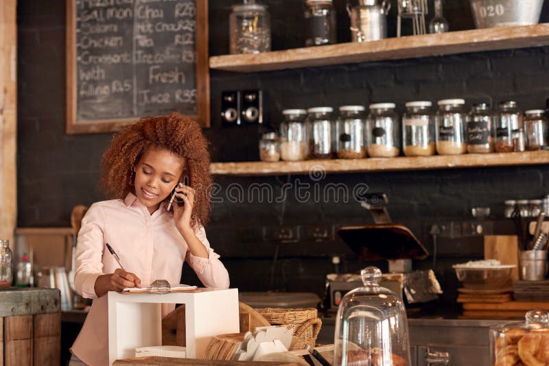 Running her cafe with ease stock photo. Image of owner - 72700672