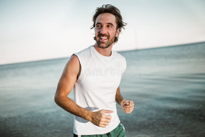 Man Jogging on Beach. Male Runner Training Outside Working Out Stock ...