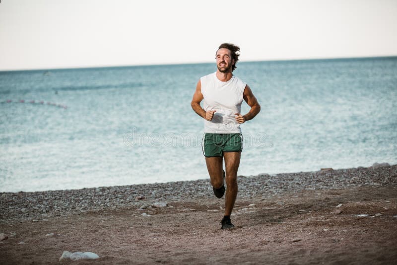 Man Jogging on Beach. Male Runner Training Outside Working Out Stock ...