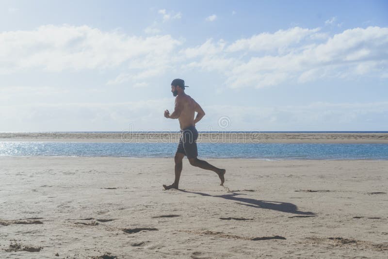 Running Man Jogging on Beach.Muscular Male Runner Training Outside ...