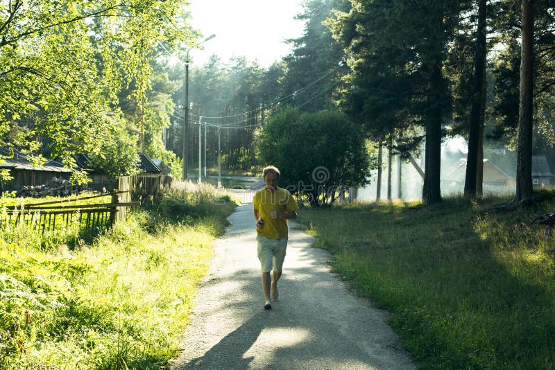 A Running Man Jogging in the Countryside in the Summer. Stock Image ...