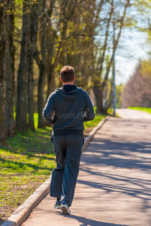 Running Man in the Park View from Back Stock Photo - Image of motion ...