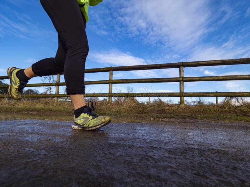 Running on a muddy trail stock image. Image of caucasian - 209216455