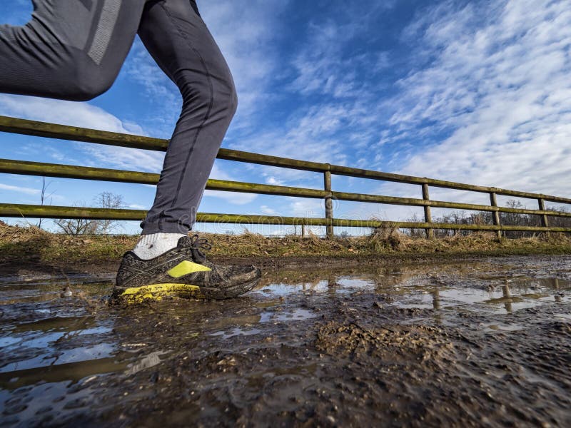 Running on a muddy trail stock image. Image of hiking - 245052579