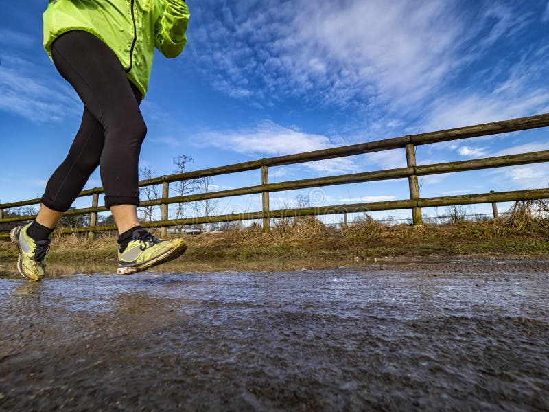Running on a muddy trail stock image. Image of outdoor - 245052569