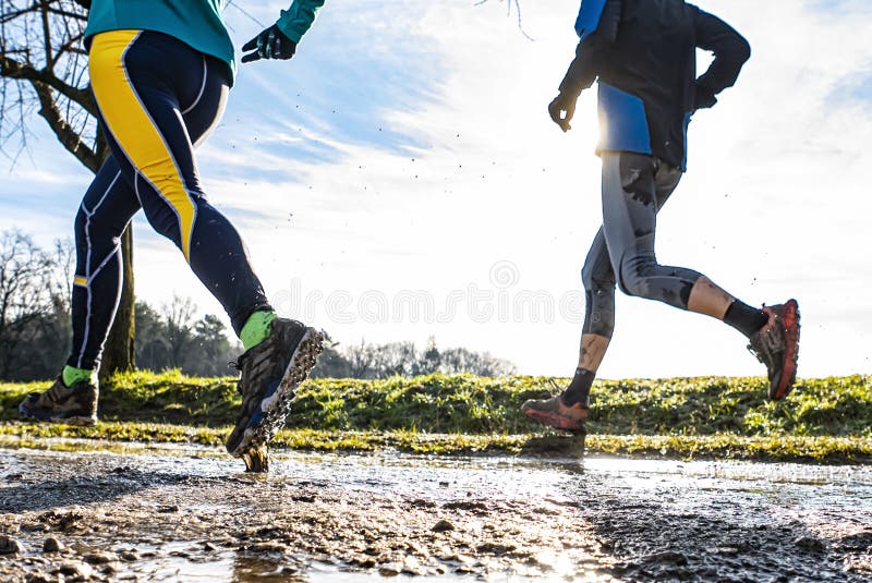 Running on a muddy trail stock photo. Image of legs - 208578282