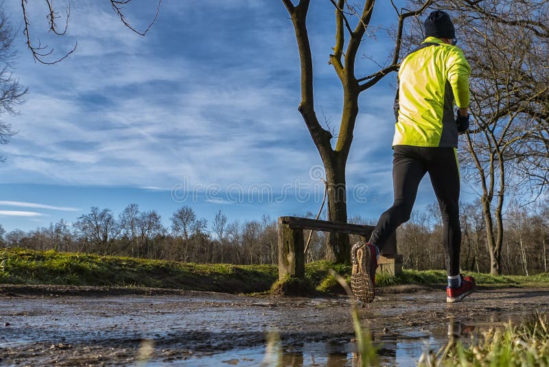 Running on a muddy trail stock image. Image of outdoor - 244659409