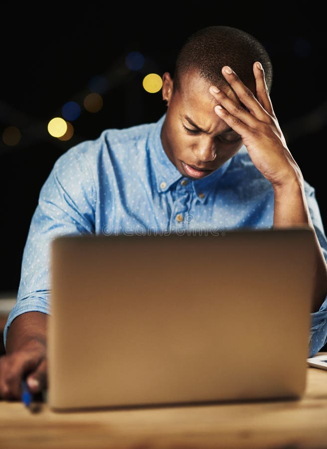 Running Out of Time. a Young Man Looking Stressed while Working Late ...