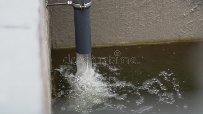 Running Stream of Treated Water from Pipe into Storage Basin Stock ...