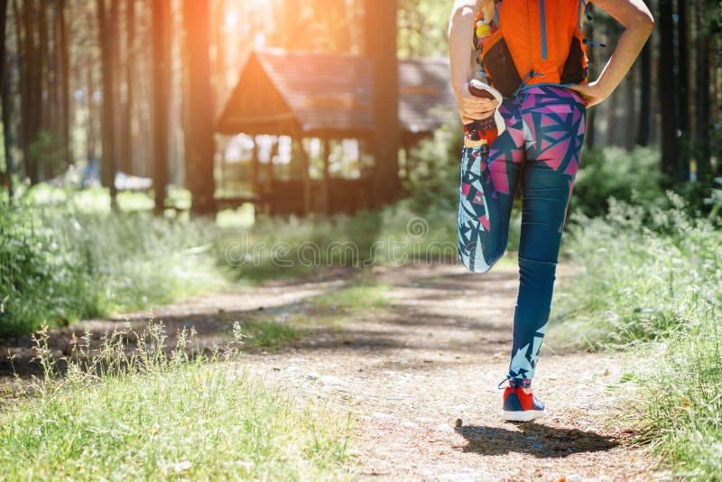 Running Stretching - Female Runner Jogging before Doing Leg Stretching ...