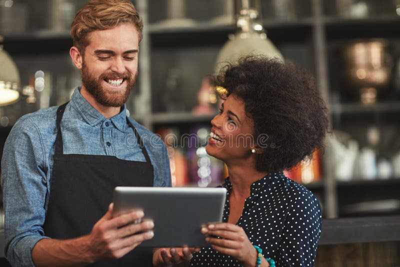 Running Their Cafe on the Wireless Network. Young Coffee Shop Workers ...
