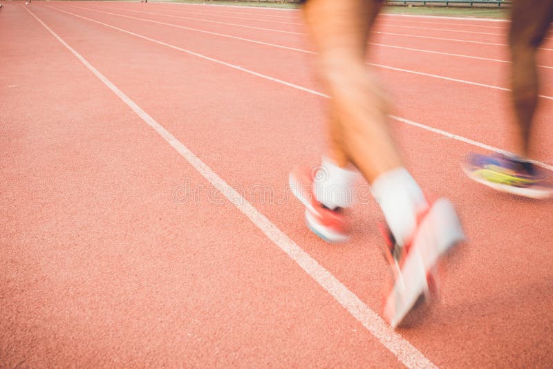 Running Track with Blur of Runner Feet in Stadium Stock Photo - Image ...