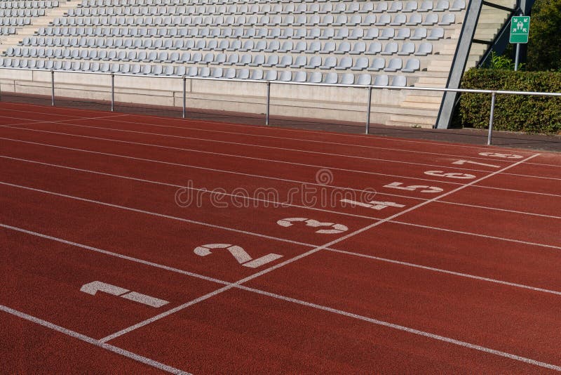 Running Track with Numbered Lanes in an Empty Stadium during Daylight ...