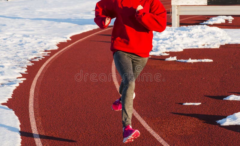 Running on a Track Surrounded by Snow Stock Photo - Image of sports ...