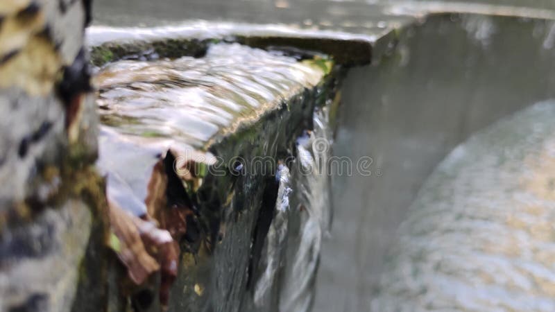 Close-Up View of Flowing Water Over Edge of Natural Structure Stock ...