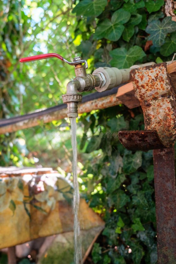 Running Water from the Rusty Water Tap in the Garden Stock Image ...