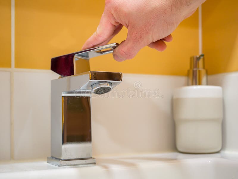 Running Water from a Square Faucet in a Modern Bathroom Stock Photo ...