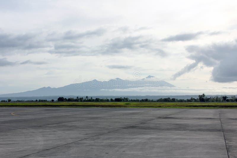 Runway with Mountain in the Background in Cloudy Day Stock Image ...