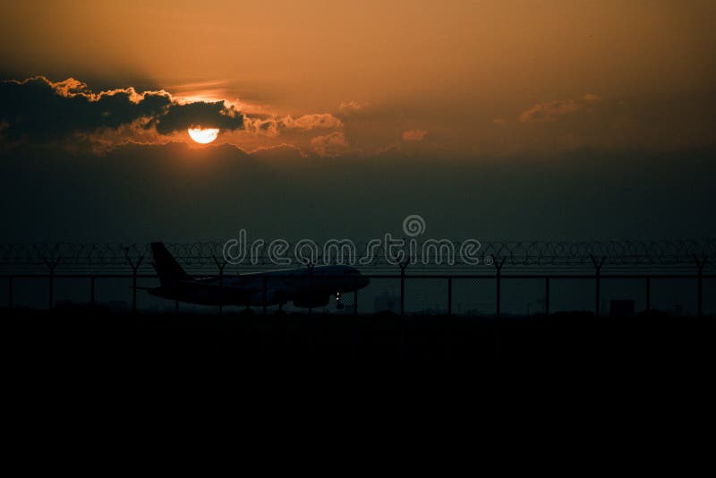 Airplane Landing On The Runway In The Evening At Sunset At The Airport ...