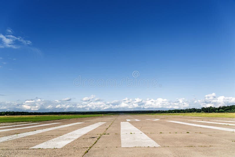 The Runway of a Rural Small Airfield Against a Blue Sky with Clouds of ...