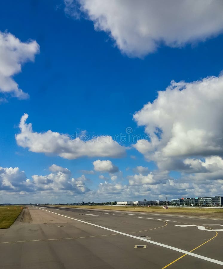 Runway Under Puffy Clouds stock photo. Image of aviation - 83772600