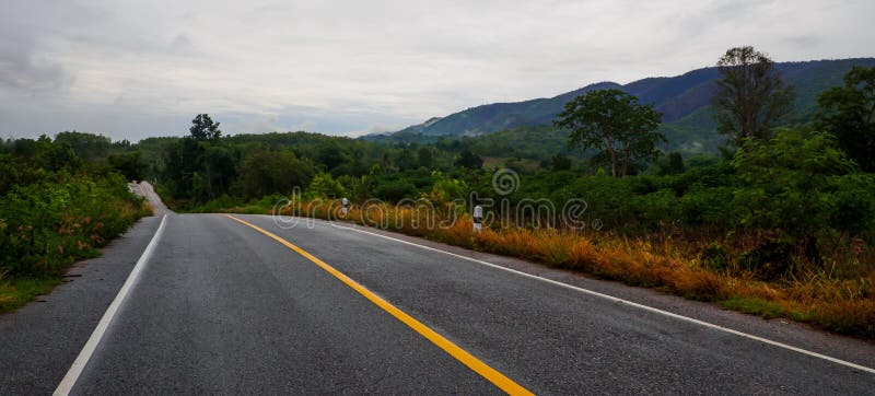 Rural asphalt sloping path stock image. Image of environment - 187368319