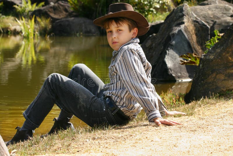 Rural Boy Sitting by Riverbank Stock Photo - Image of country ...