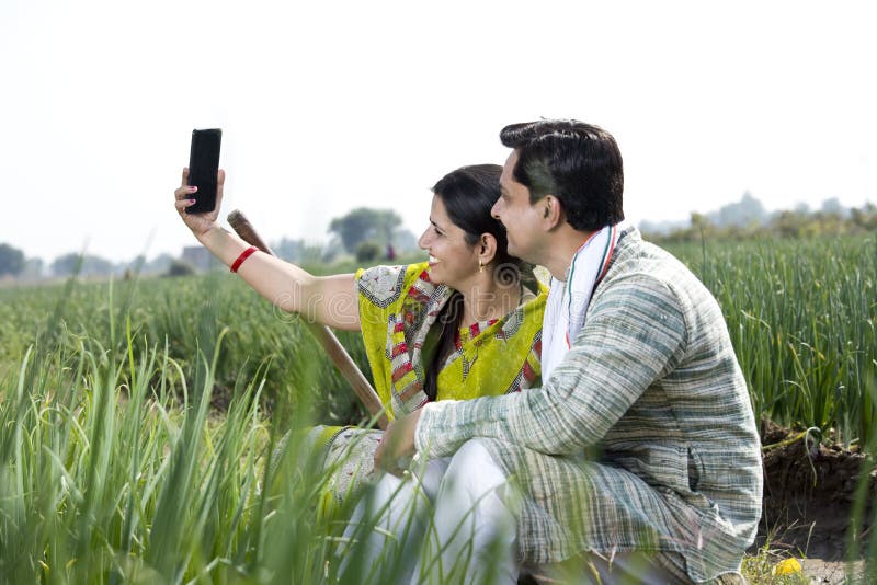 Rural Couple Using Mobile Phone in Agricultural Field Stock Photo ...