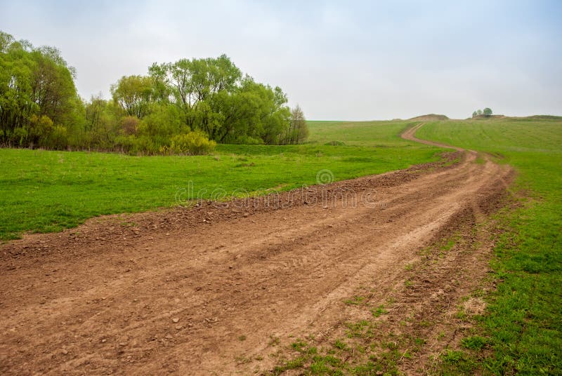 Rural Dirt Road in Rural Areas. Green Fields, Trees and a Sky with ...