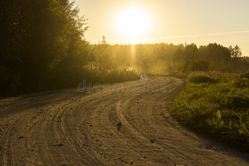 Rural dirt road at sunset stock image. Image of country - 64246877