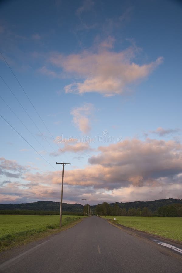Rural Highway Under Sunset Clouds Stock Photo - Image of vertical, road ...