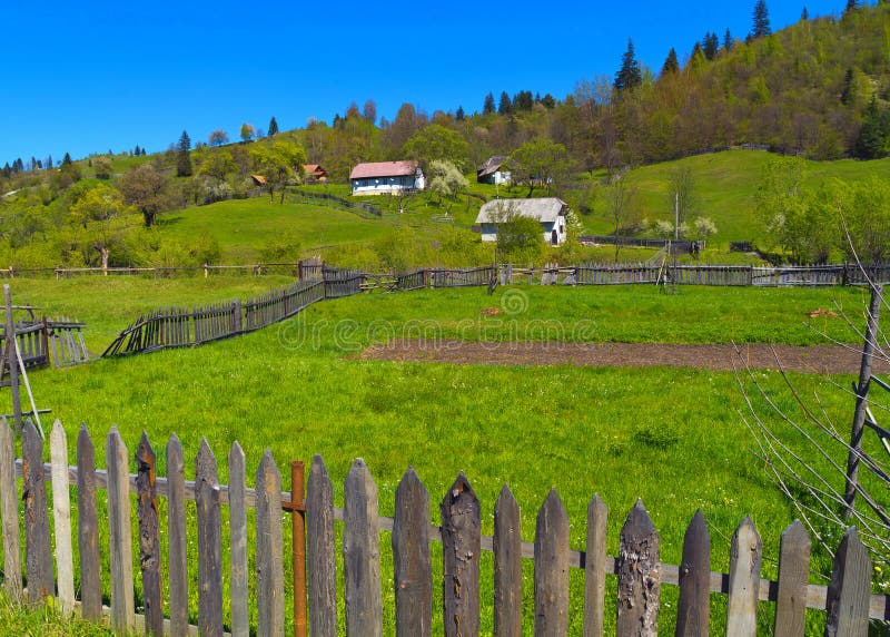 Rural Landscape Of Fields Separated By Wood Fences At Spring In