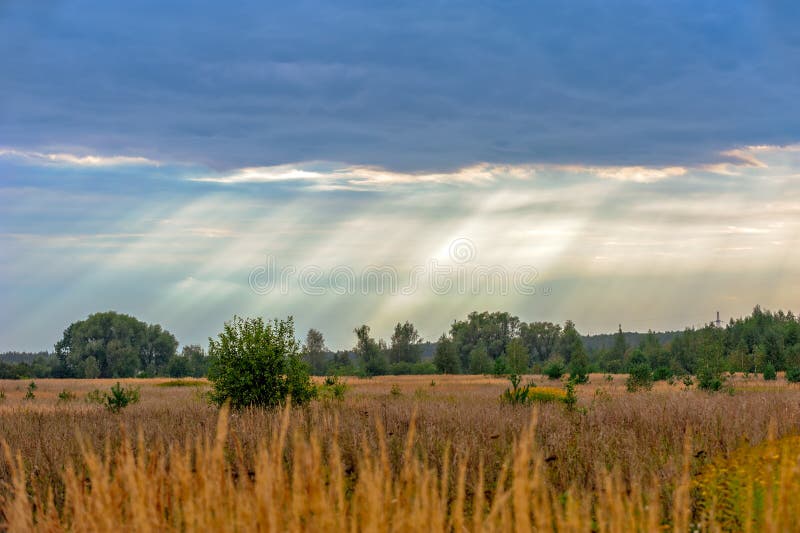 Rural Landscape and Sun Rays through Clouds Stock Photo - Image of blue ...
