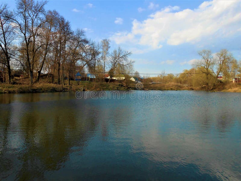 Rural pond in the spring. stock image. Image of deep - 115297297