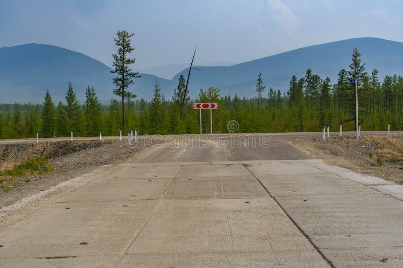 Rural Road Intersection with Forest and Mountains in the Background ...