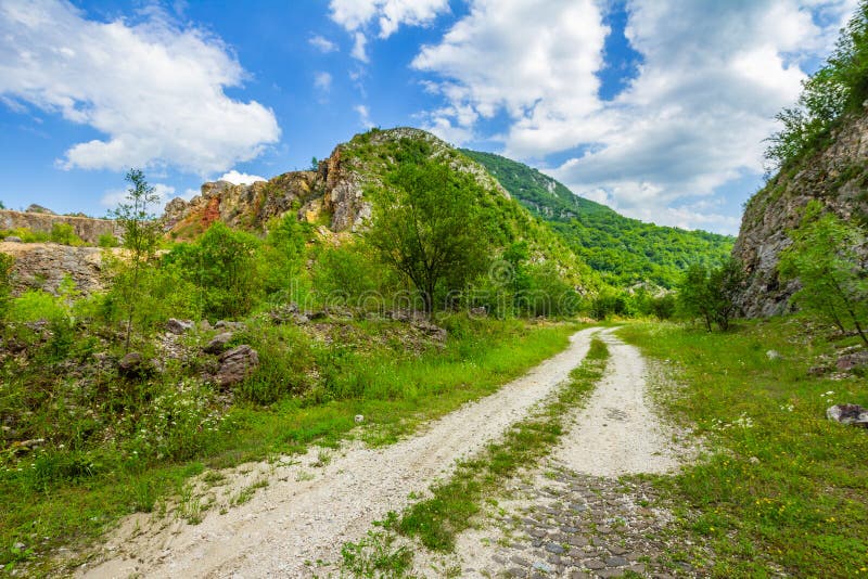 Rural Road with Small Vegetation and Cliffs Stock Image - Image of dirt ...