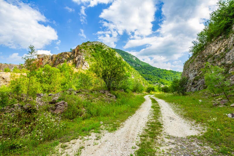 Rural Road with Small Vegetation and Cliffs Stock Photo - Image of ...