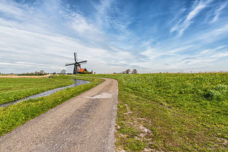 A Rural Road and Windmill in Netherlands Stock Image - Image of blade ...