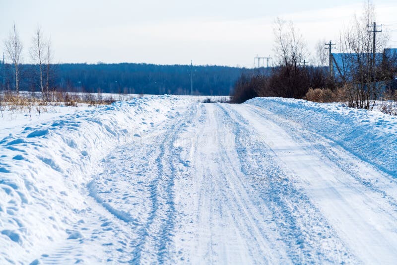 Rural Road in Winter Covered with Rolled Snow on the Background of Snow ...