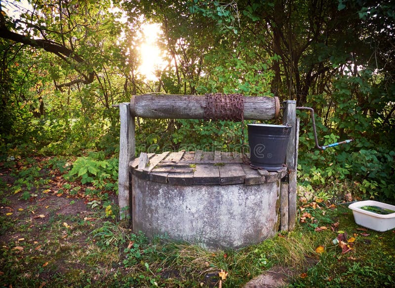 Rural well with bucket stock photo. Image of forsaken - 60342084
