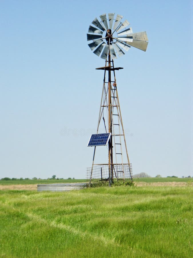 Rural Windmill Equipped with a Solar Panel Stock Photo - Image of field ...