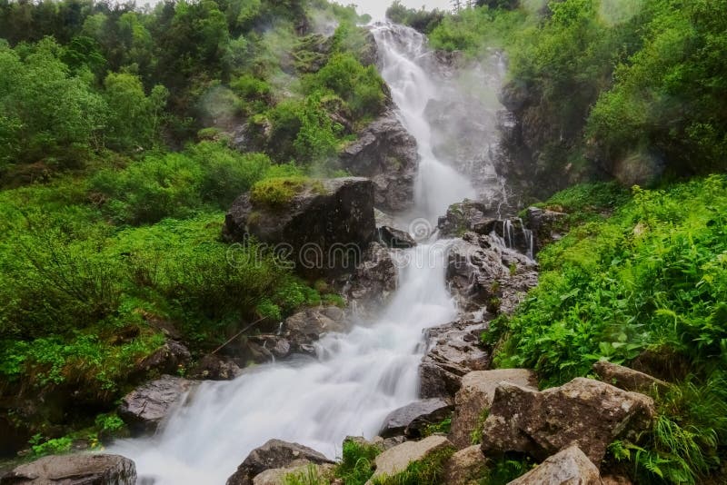 Rushing Large Waterfall with Huge Rocks in the Mountains Stock Photo ...