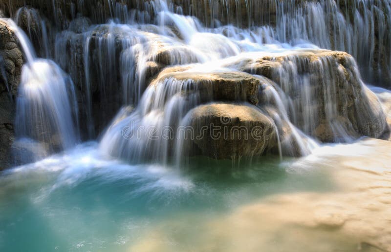 Rushing Water from a Waterfall Flowing into the Blue Sea Stock Photo ...