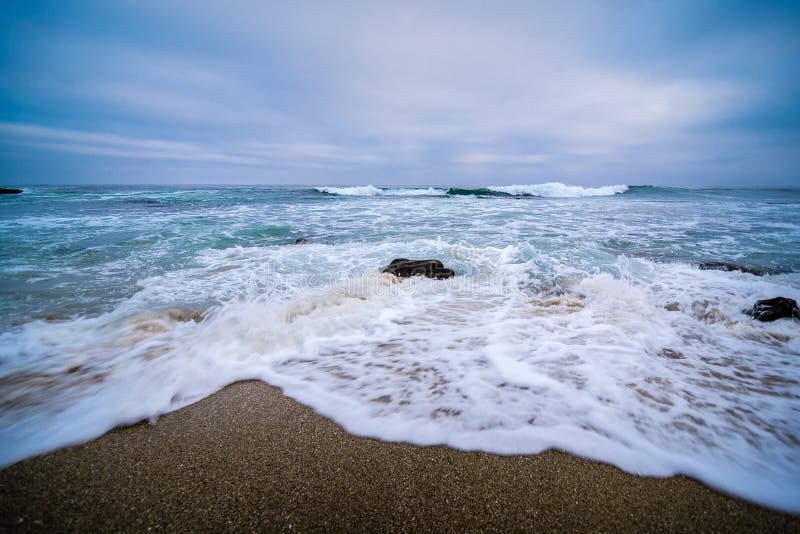 Waves rush in stock photo. Image of beach, yellow, rock - 102257238