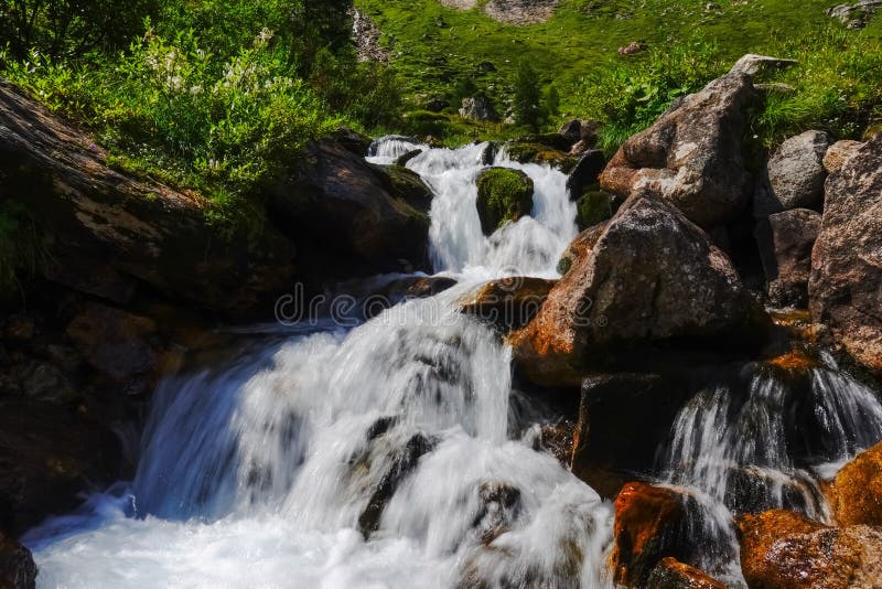 Rushing White Waterfall Over Rocks in the Sun while Hiking Stock Image ...