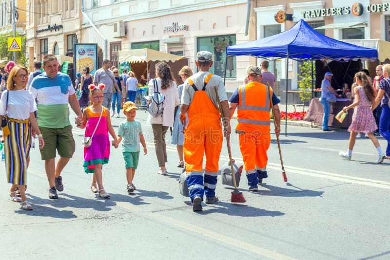 Community Workers are Walking Along the Street with a Tool in Their ...