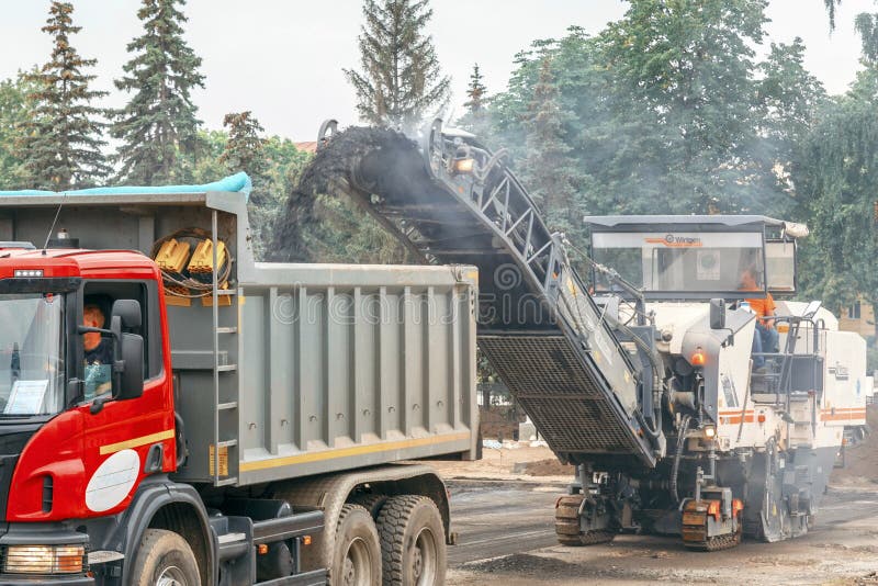 Cutting Old Asphalt with a Special Machine and Loading it into a Dump ...